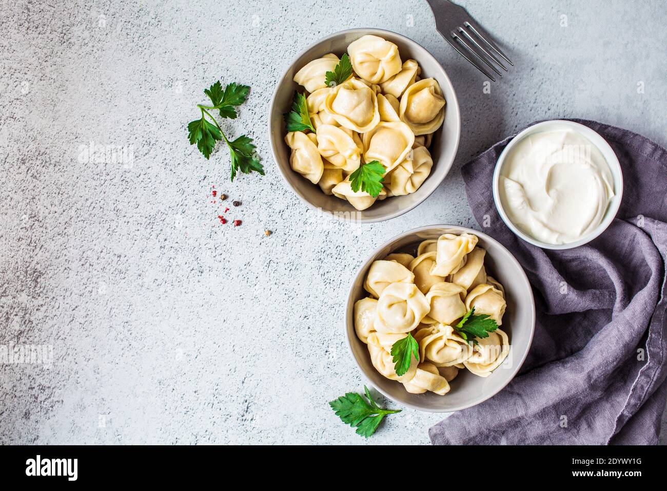 Traditional Russian meat dumplings with sour cream and parsley. Russian ...