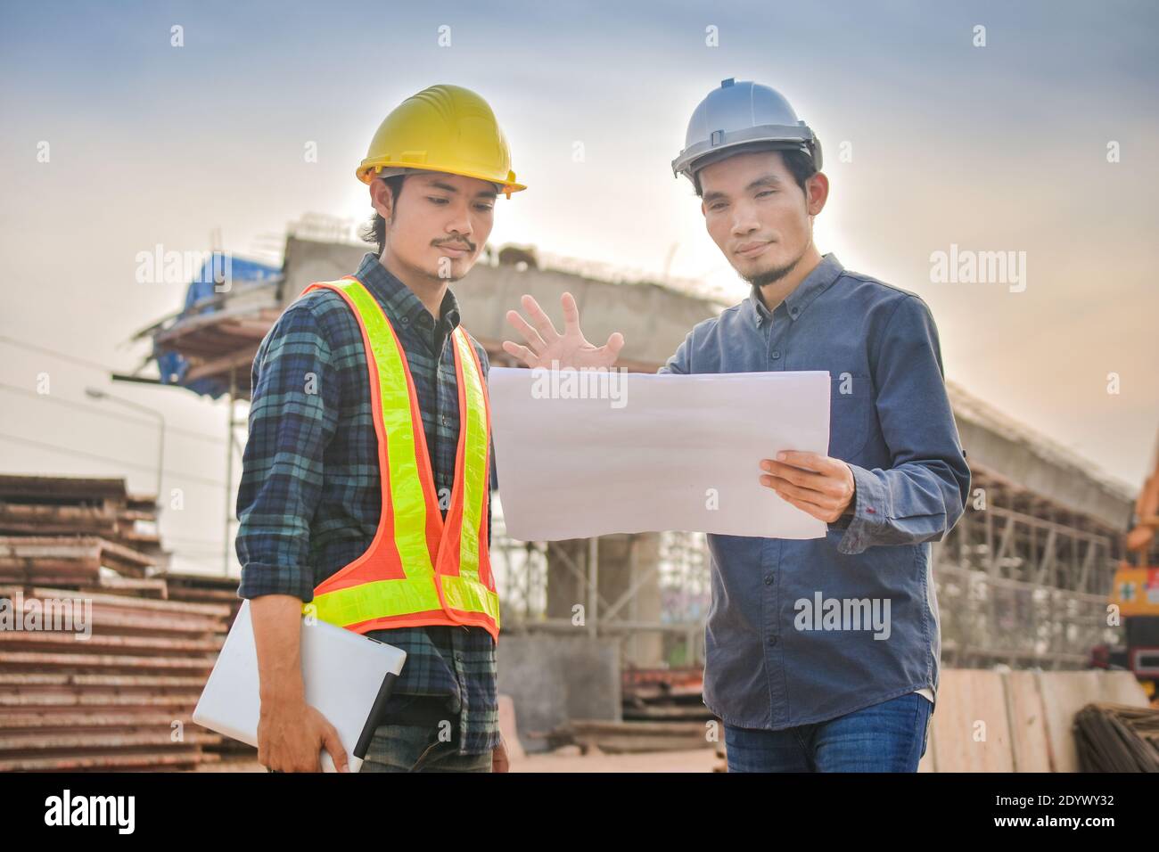 Supervisor use blueprint talking with Foreman Construction site ...