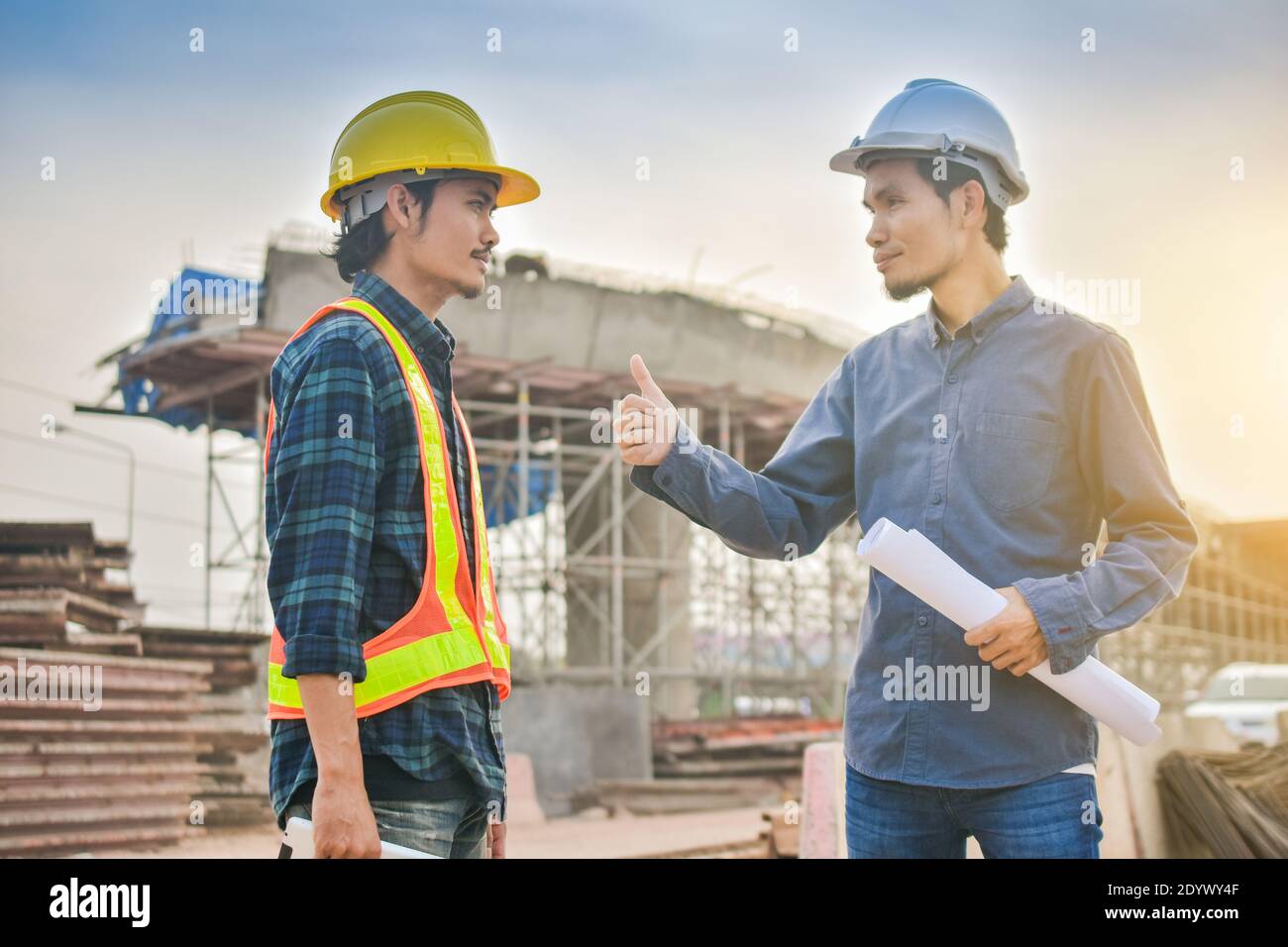 Engineer talking with Foreman Construction site background architecture ...