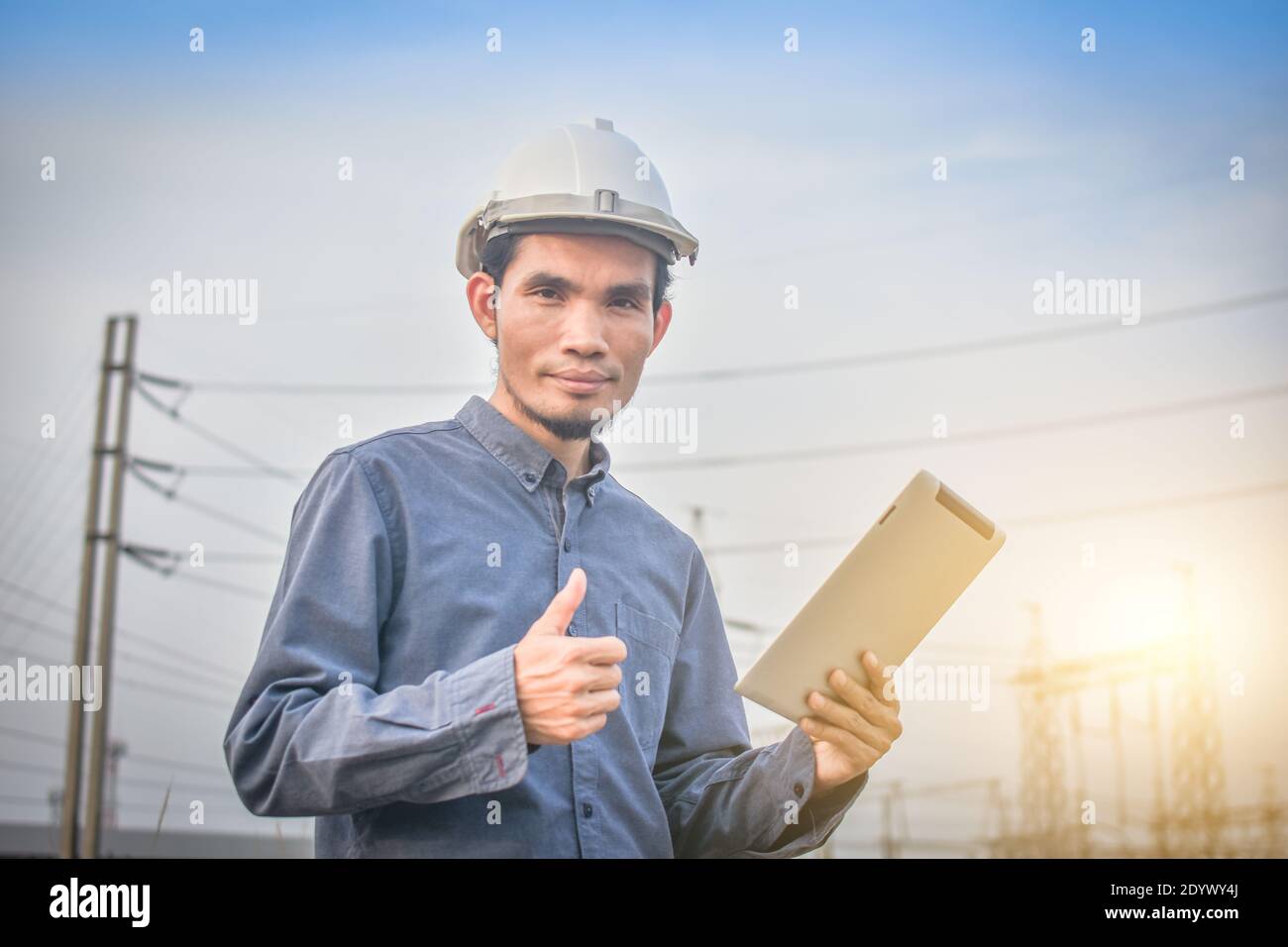 Electrical engineer uses a tablet to inspect Power plant network For ...