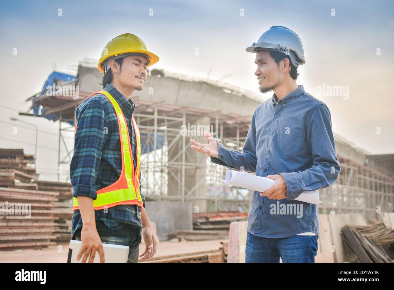 Engineer talking with Foreman Construction site background architecture ...