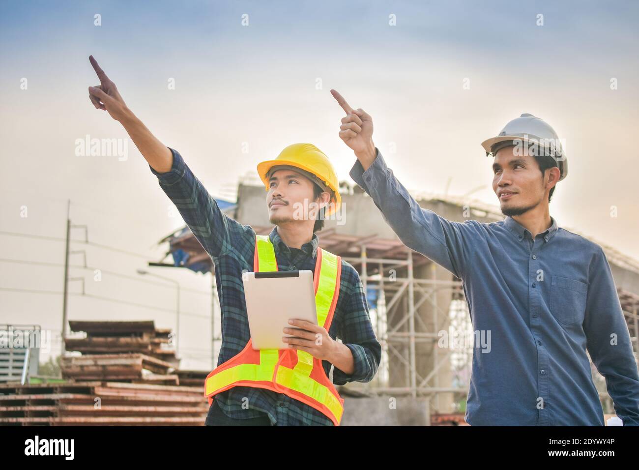 Engineer talking with Foreman Construction site background architecture ...