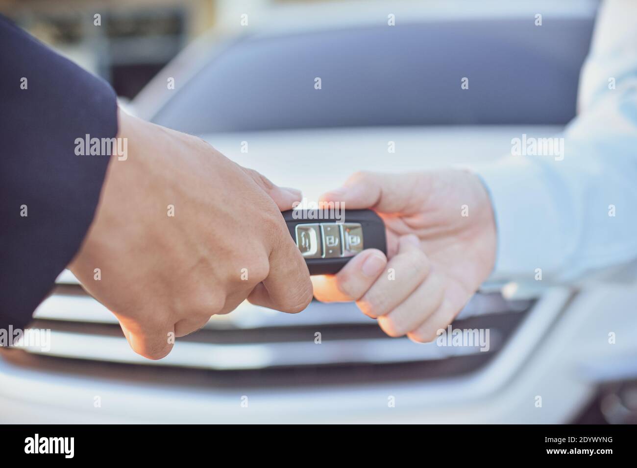 Salesman giving key car to customer,Car sale concept Stock Photo - Alamy