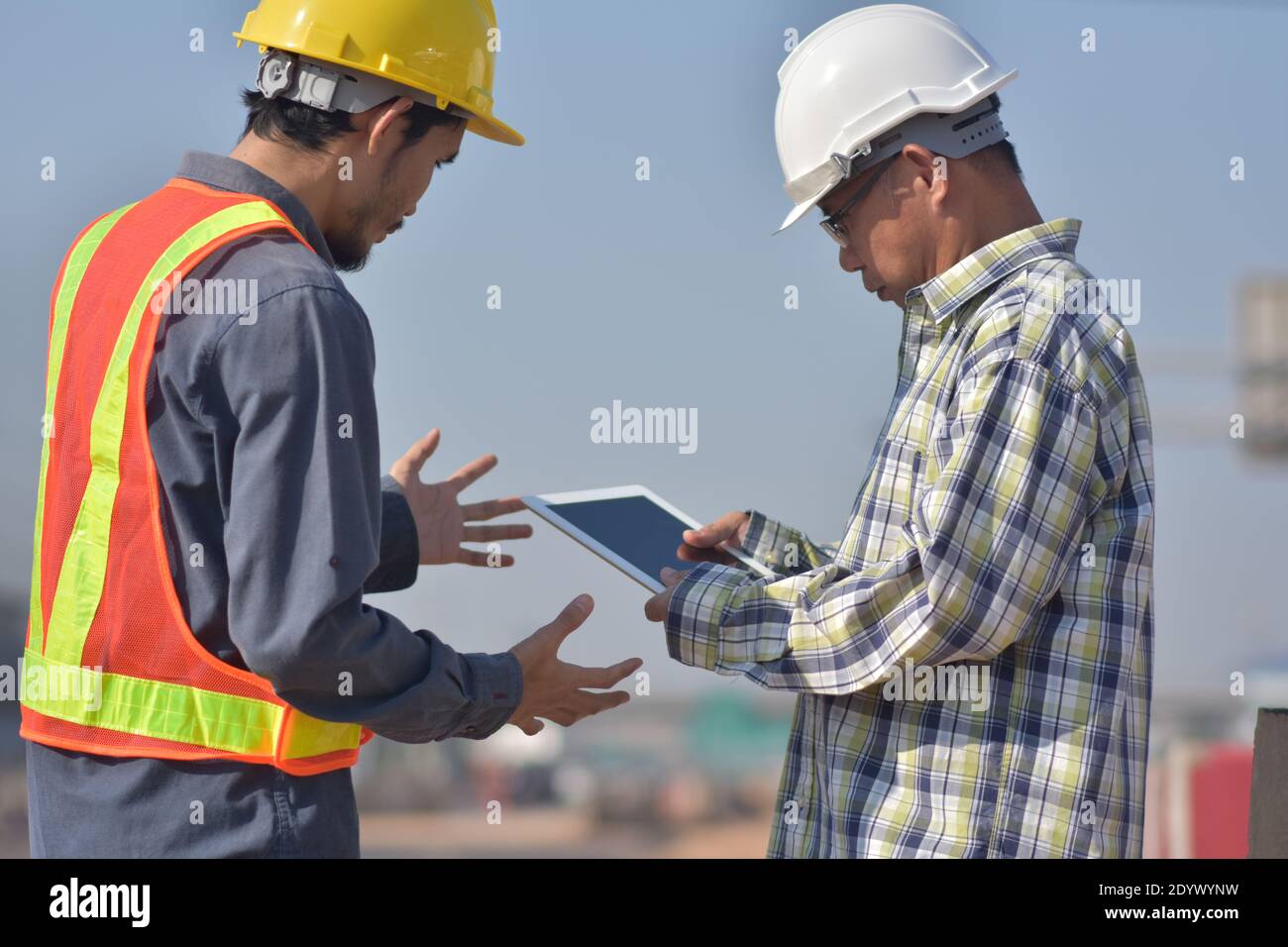 Engineering holding tablet work on road construction Stock Photo - Alamy