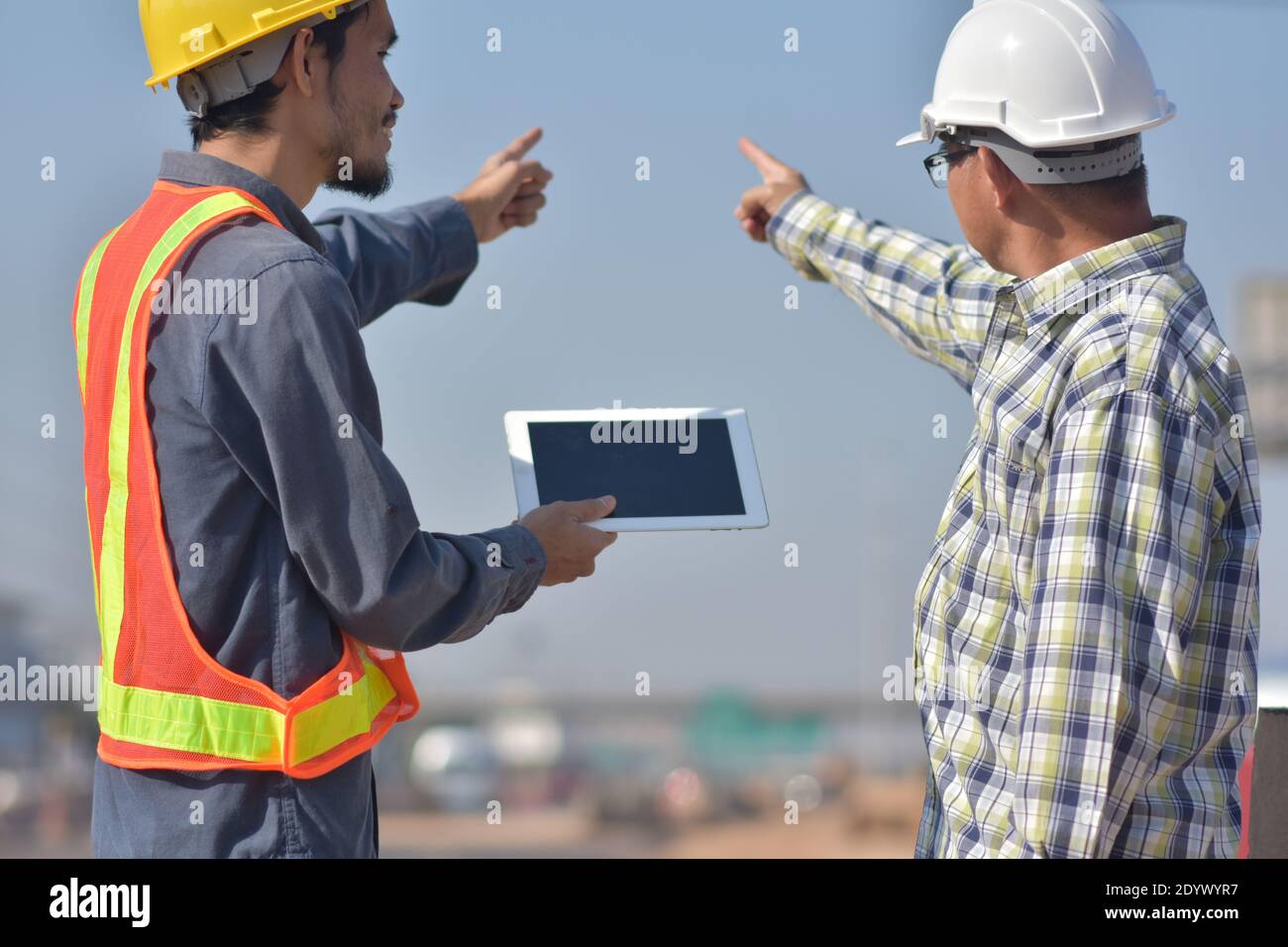 Engineering holding tablet work on road construction Stock Photo - Alamy