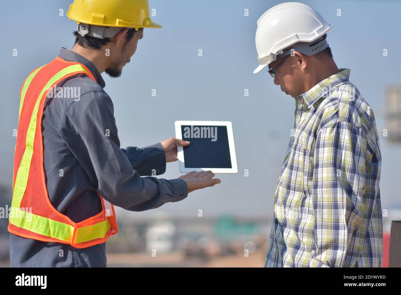 Engineering holding tablet work on road construction Stock Photo - Alamy