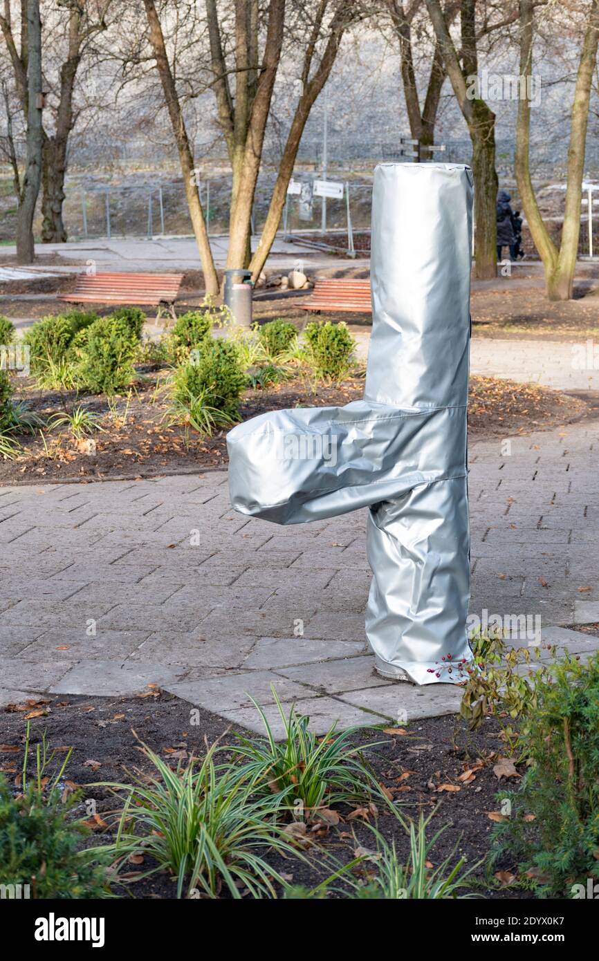 Fountain in a park covered with plastic bag protection to protect from ...