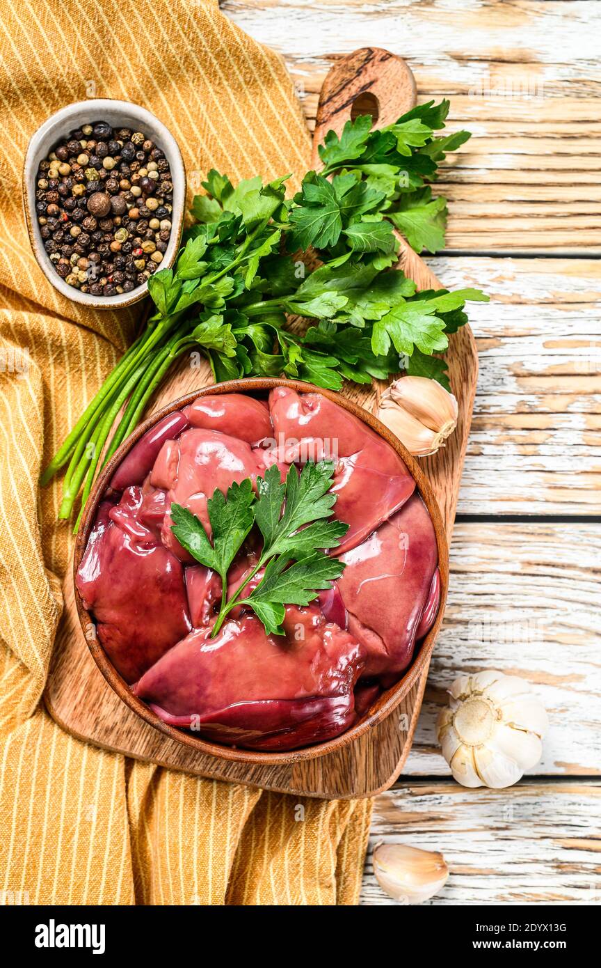 Raw fresh duck liver in a bowl. White background. Top view Stock Photo ...