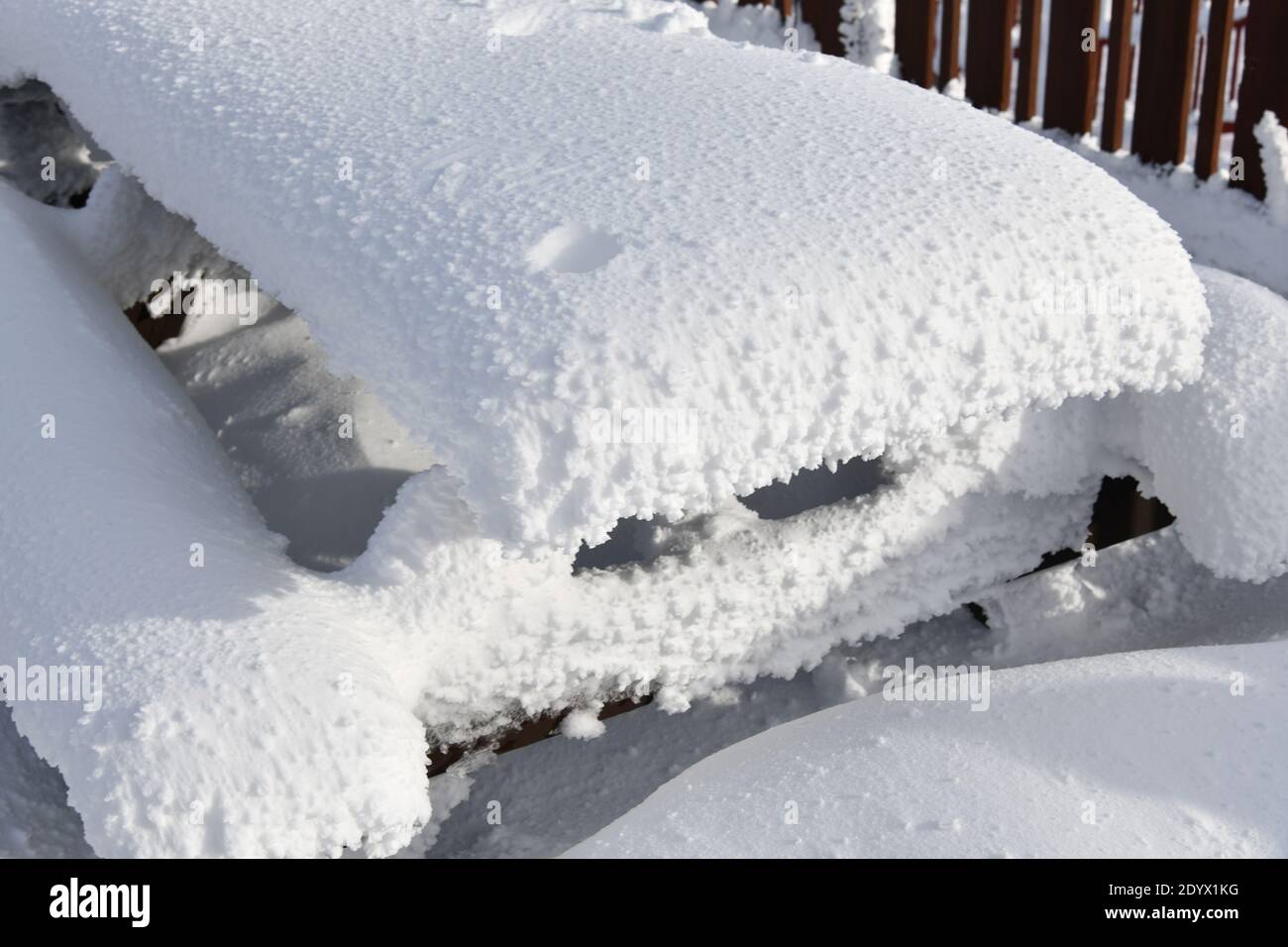 Fresh snow on the cafe table observation deck at peak Mansfield summit ...