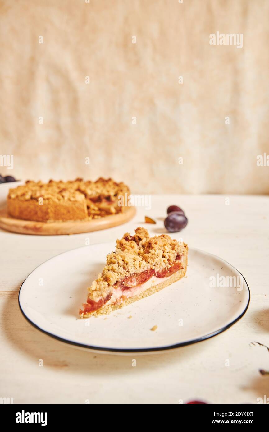 Vertical shot of a plate with a slice of delicious plum cake Stock ...