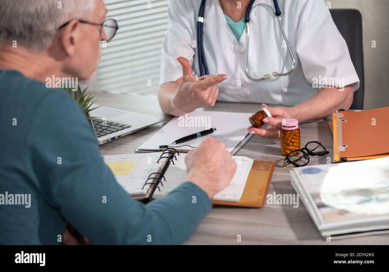 Female doctor explaining medicine to her patient in medical office ...