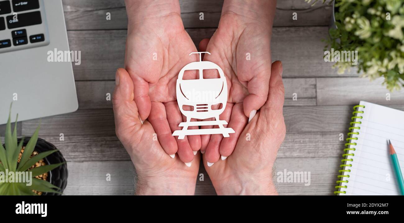 Concept of train travel insurance with paper train in hands Stock Photo ...