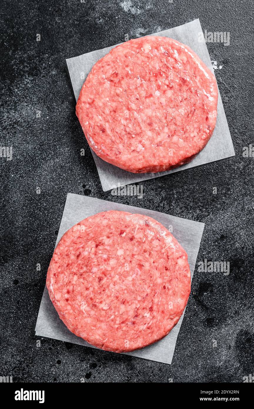 Raw Burger patties, ground beef meat. Black background. Top view Stock ...