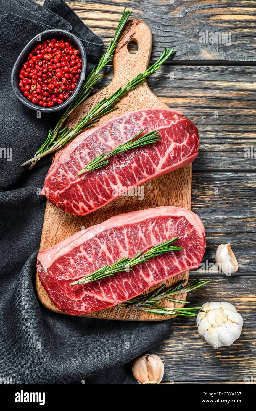 Raw marbled beef steak, top blade meat steak. Black background. Top ...