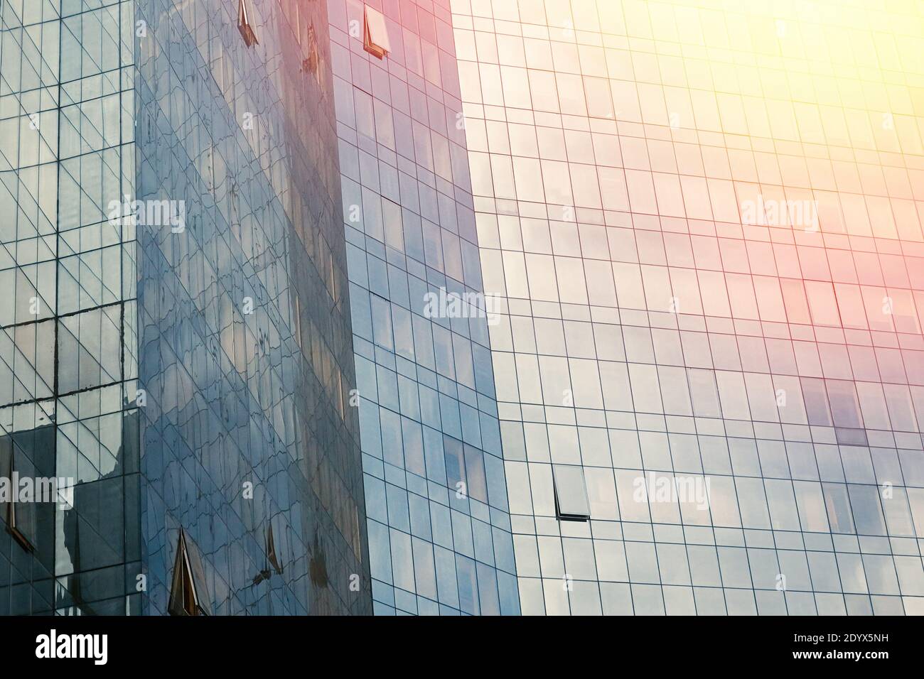 Office building windows in the background with blue reflections. Sun ...