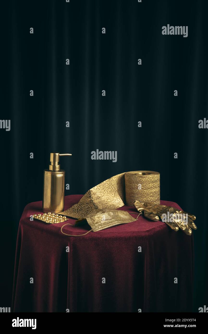 Classic still life with golden toilet paper, face mask and antiseptic ...