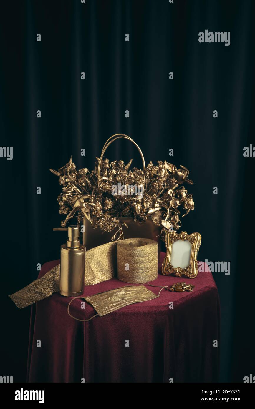 Classic still life with golden toilet paper, face mask and antiseptic ...