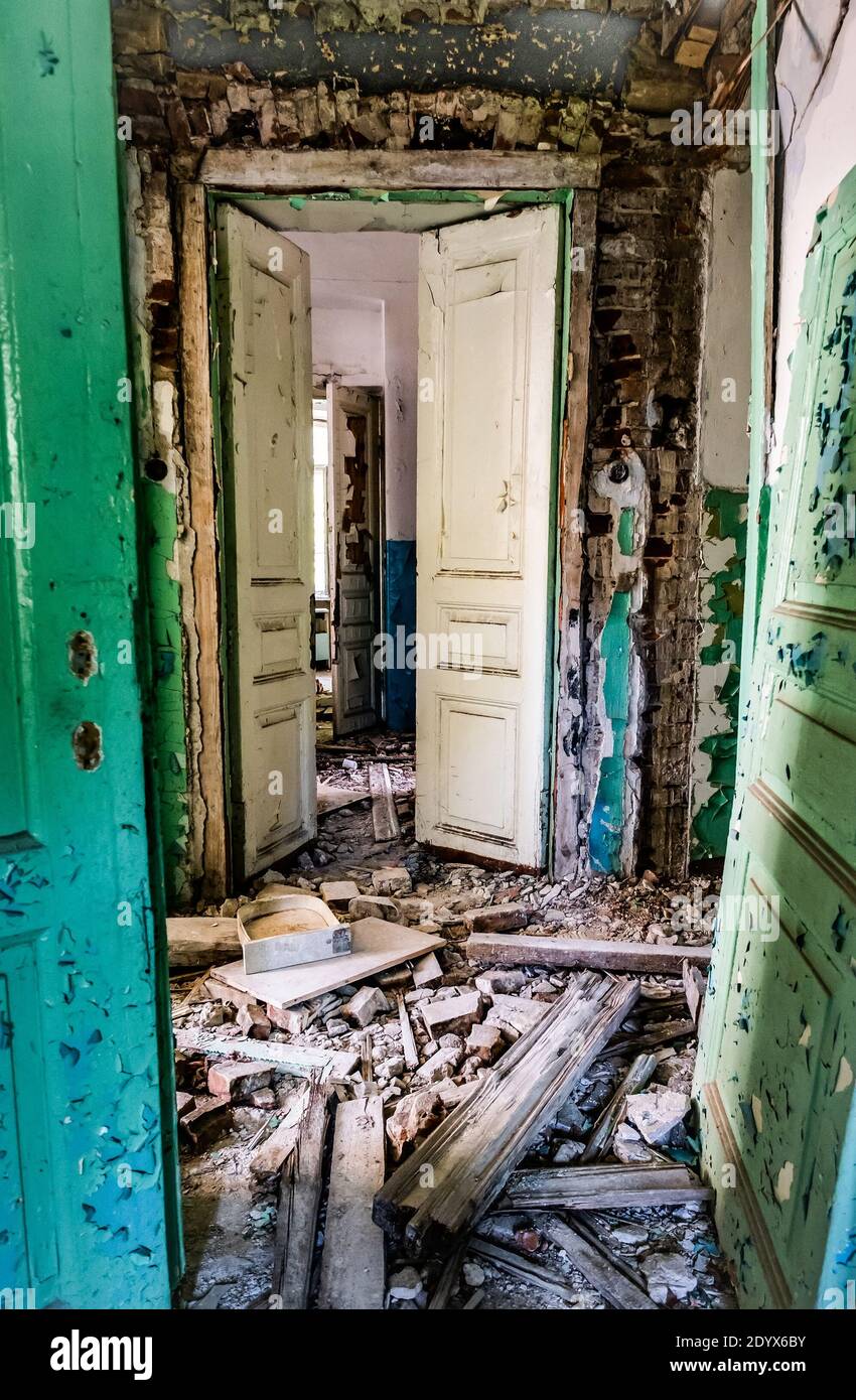 Ruined corridor with piles of garbage in abandoned building Stock Photo ...