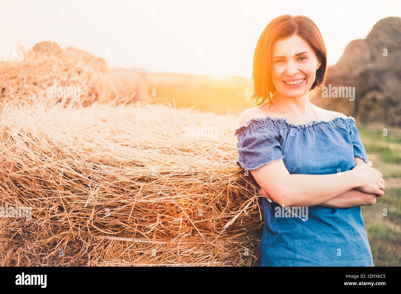 Smiling woman near haystack outdoor in countryside Stock Photo - Alamy