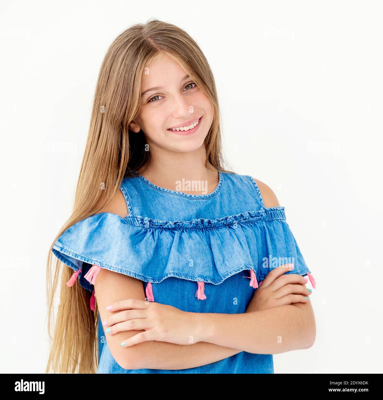 Cute girl standing half-turn with arms crossed Stock Photo - Alamy