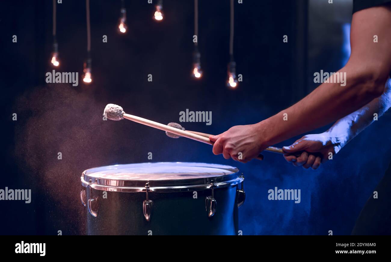 The percussionist plays with sticks on the floor tom on under studio ...