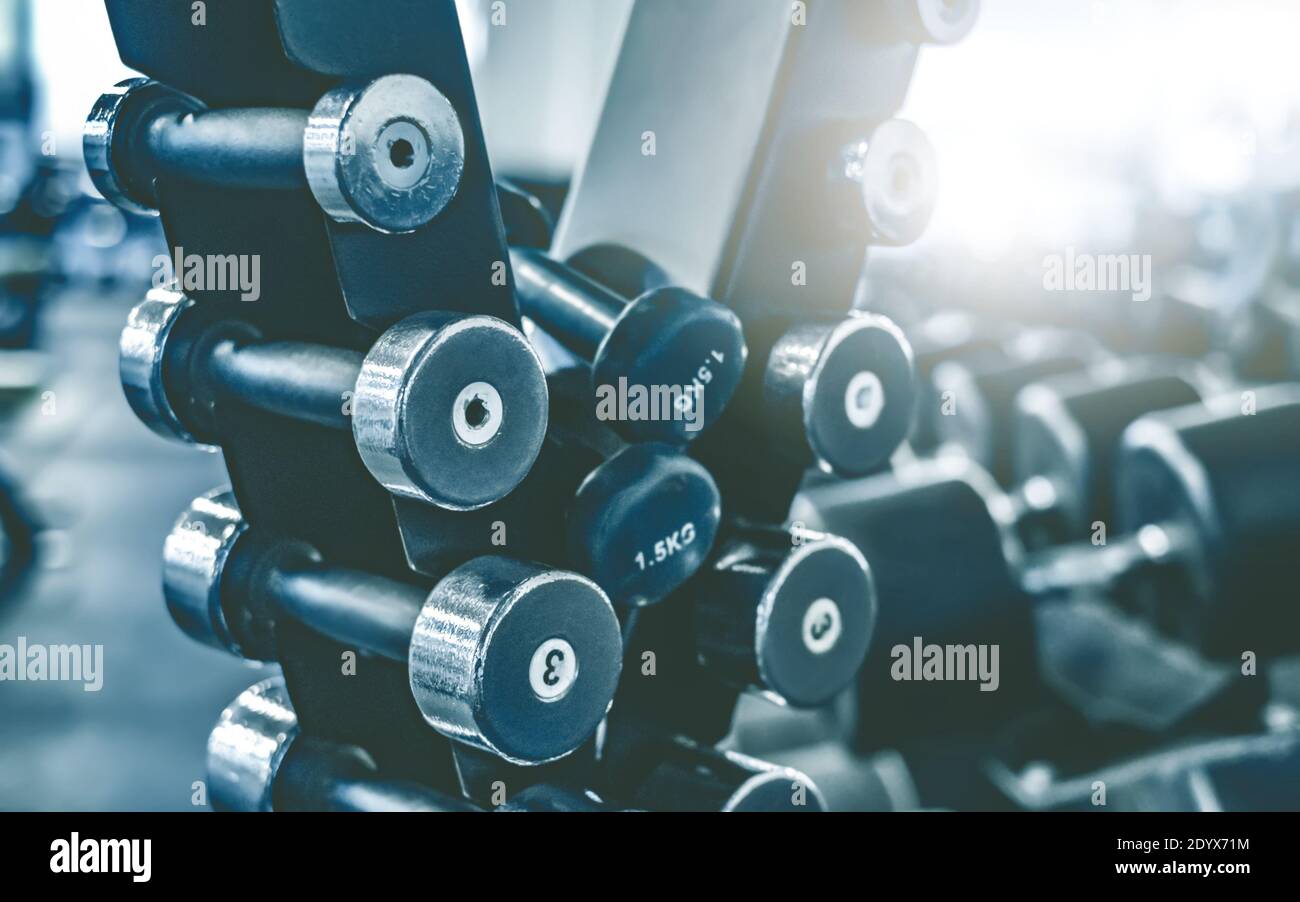 Fitness dumbbells in a gym Stock Photo - Alamy