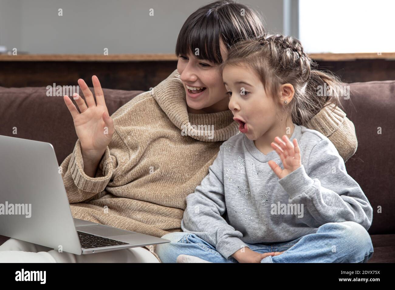 Happy family looking at laptop screen make distance video call. Smiling ...
