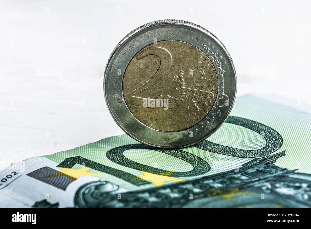 Euro currency one hundred banknote and two euro coin Stock Photo - Alamy