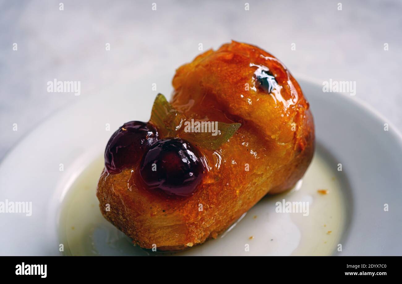 View of a baba au rhum cake in France Stock Photo - Alamy