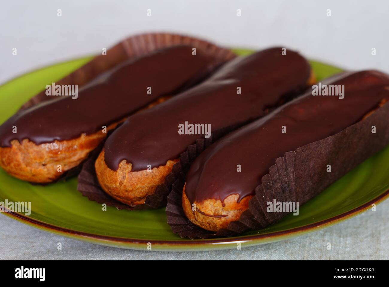 Plate of chocolate éclair pastries Stock Photo - Alamy