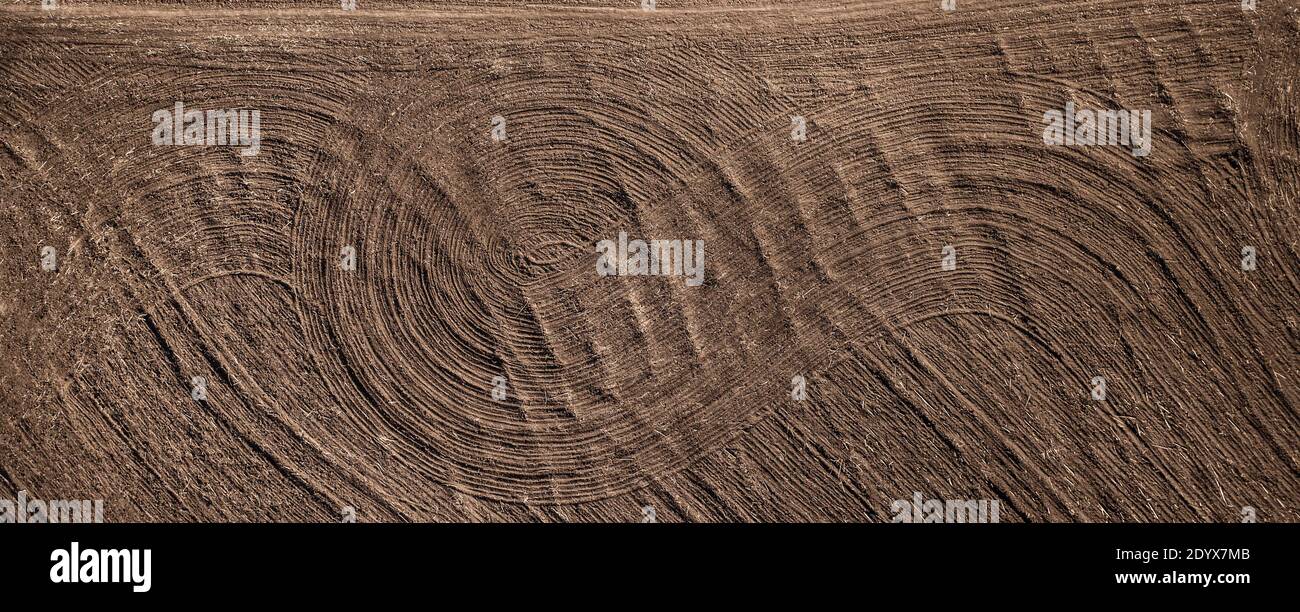 Field plowed with tractor tracks, top view Stock Photo - Alamy