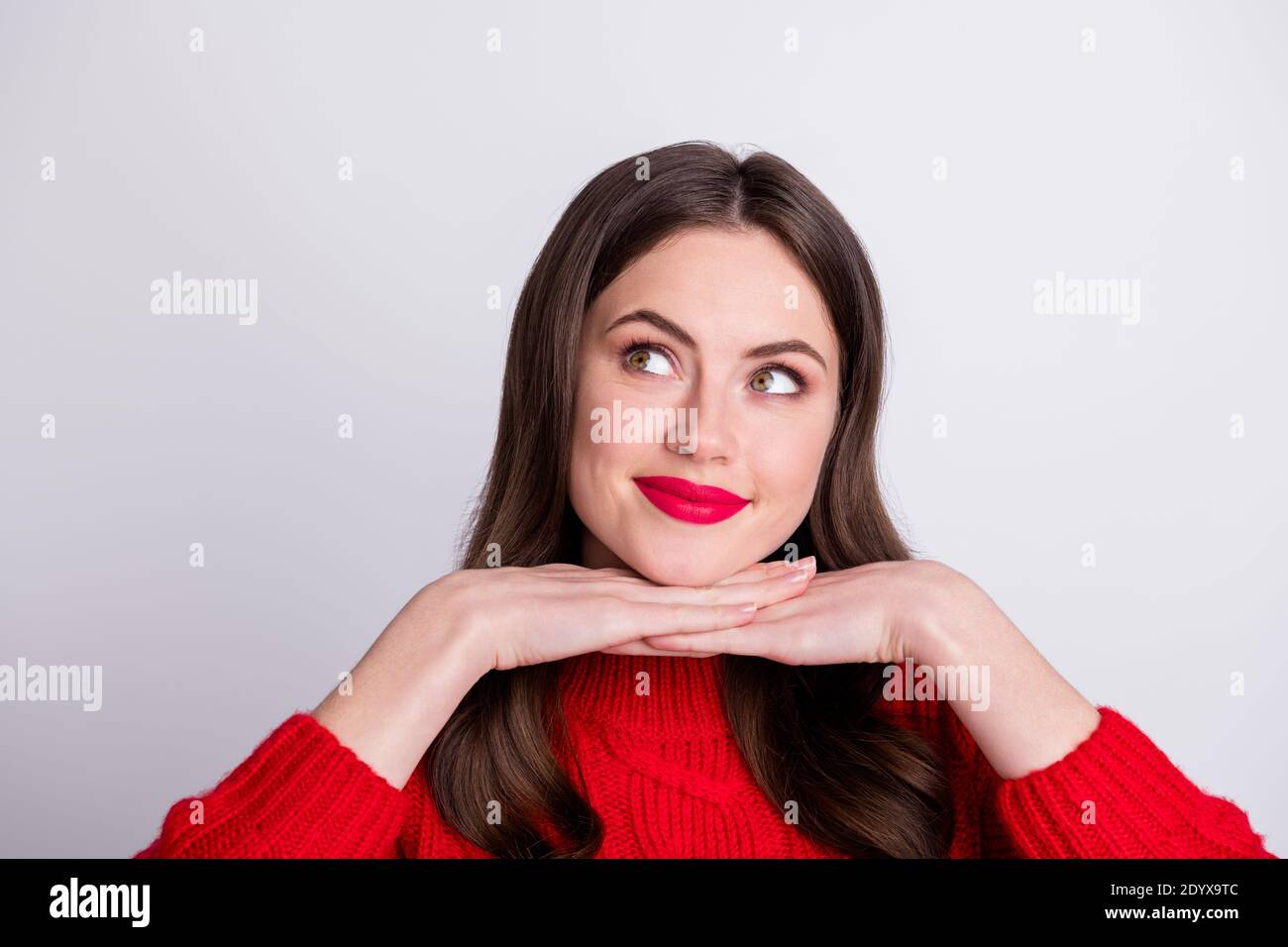 Photo portrait of pretty cunning girl keeping hands near face looking ...