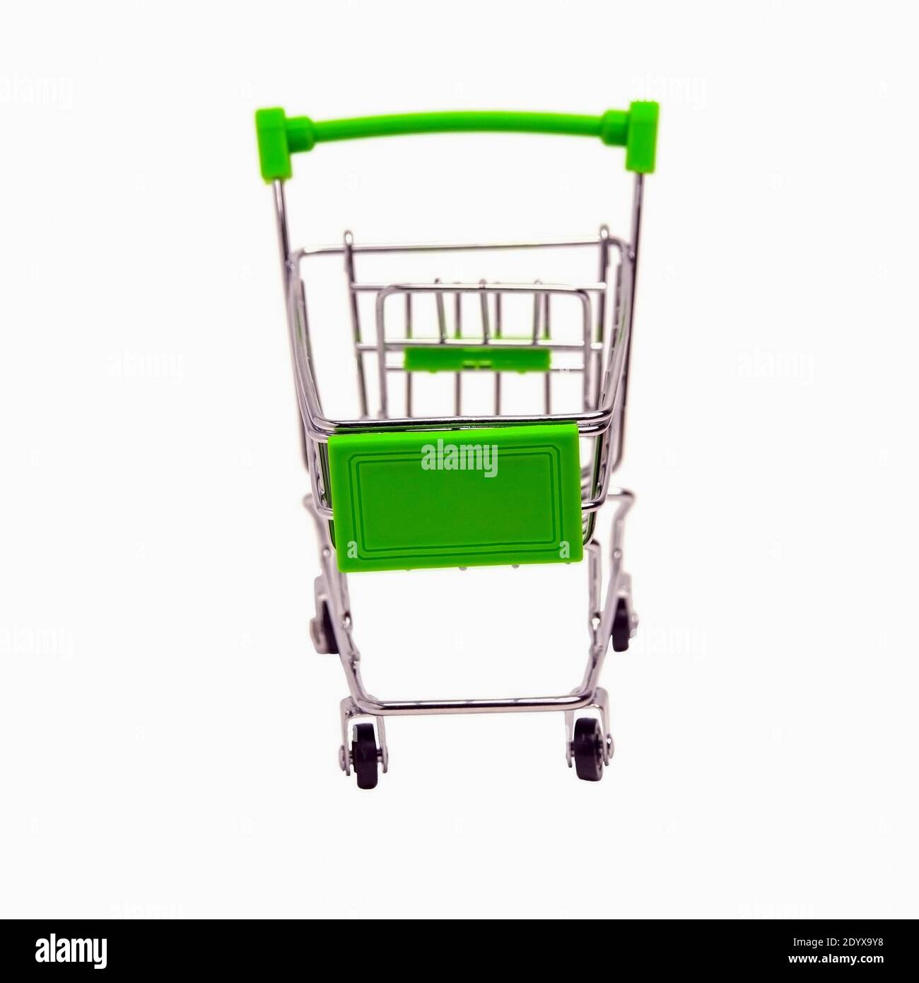 An empty shopping cart with a green handle, isolated on a white ...
