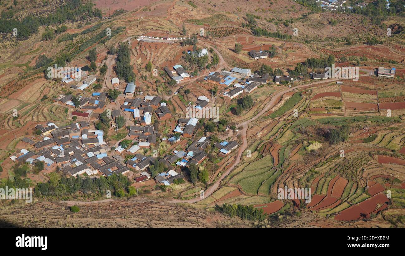 Aerial view of a plateau village: The village and its fields on a sunny ...