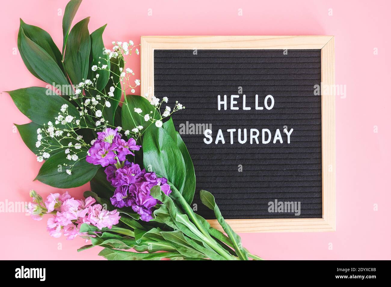 Hello Saturday text on black letter board and bouquet colorful flowers ...
