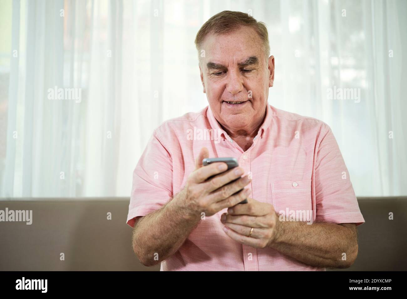 Aged man checking messages Stock Photo - Alamy