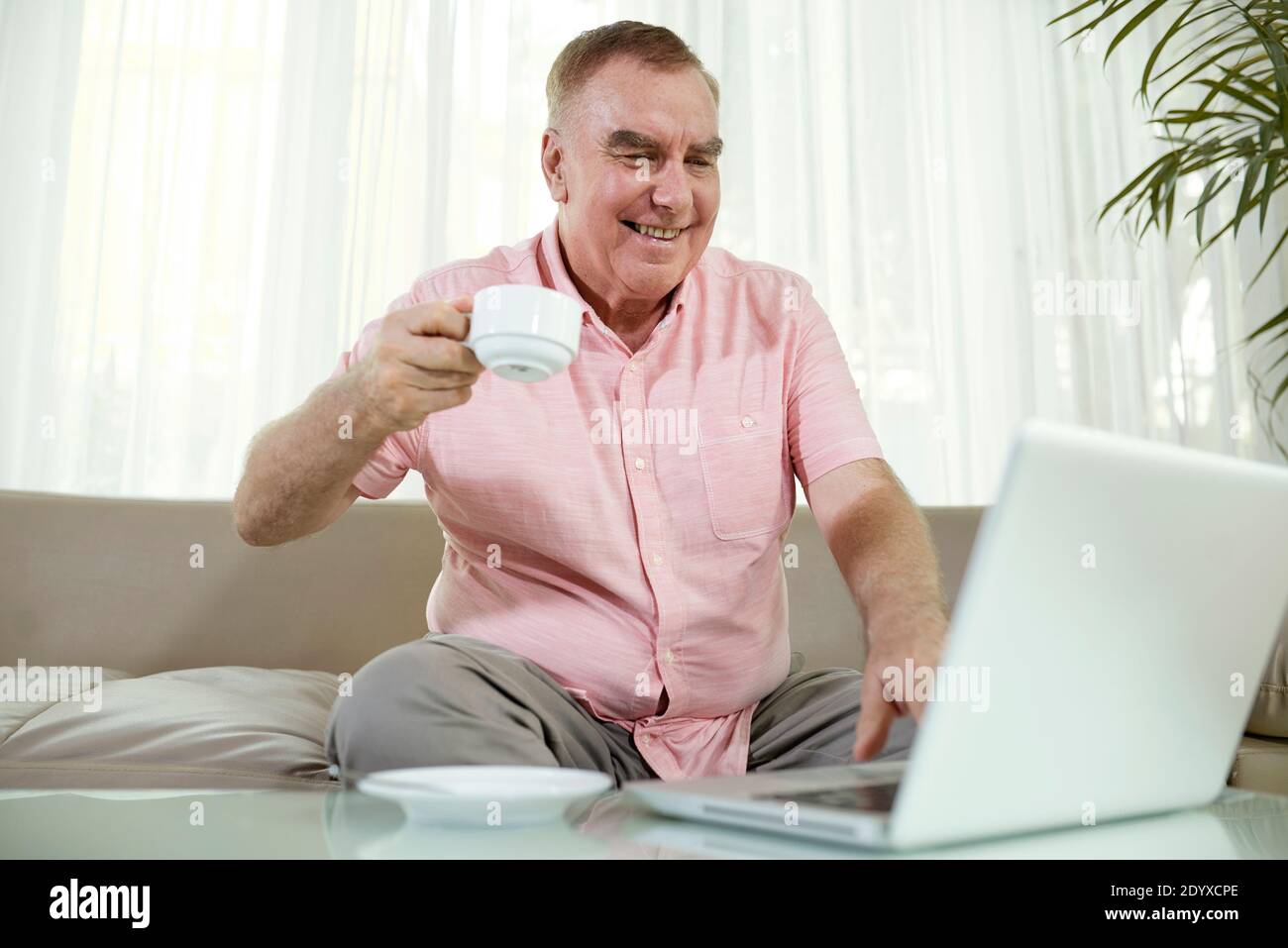 Elderly man video calling family member Stock Photo - Alamy