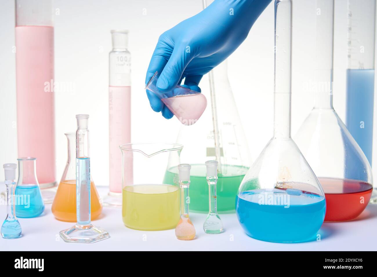 scientist hand with blue protective glove using chemical laboratory ...