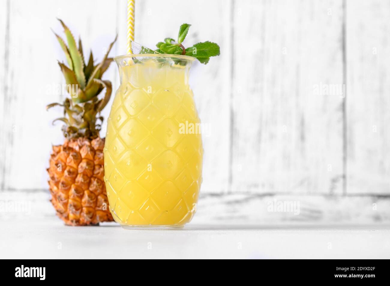 Glass of pineapple tiki style cocktail on white background Stock Photo ...