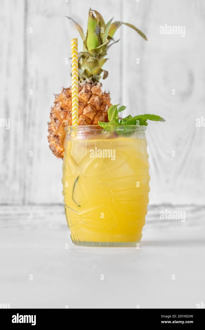 Glass of pineapple tiki style cocktail on white background Stock Photo ...