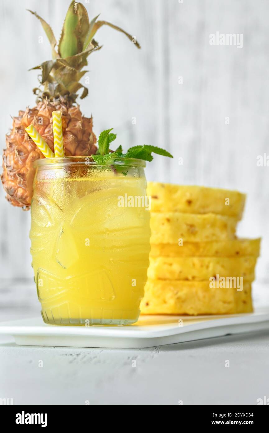 Glass of pineapple tiki style cocktail on white background Stock Photo ...