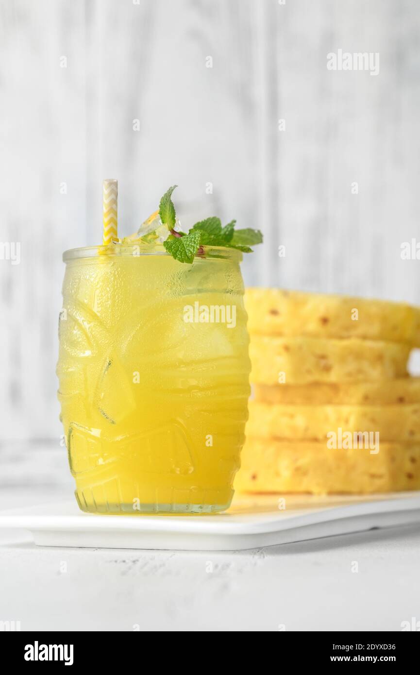 Glass of pineapple tiki style cocktail on white background Stock Photo ...