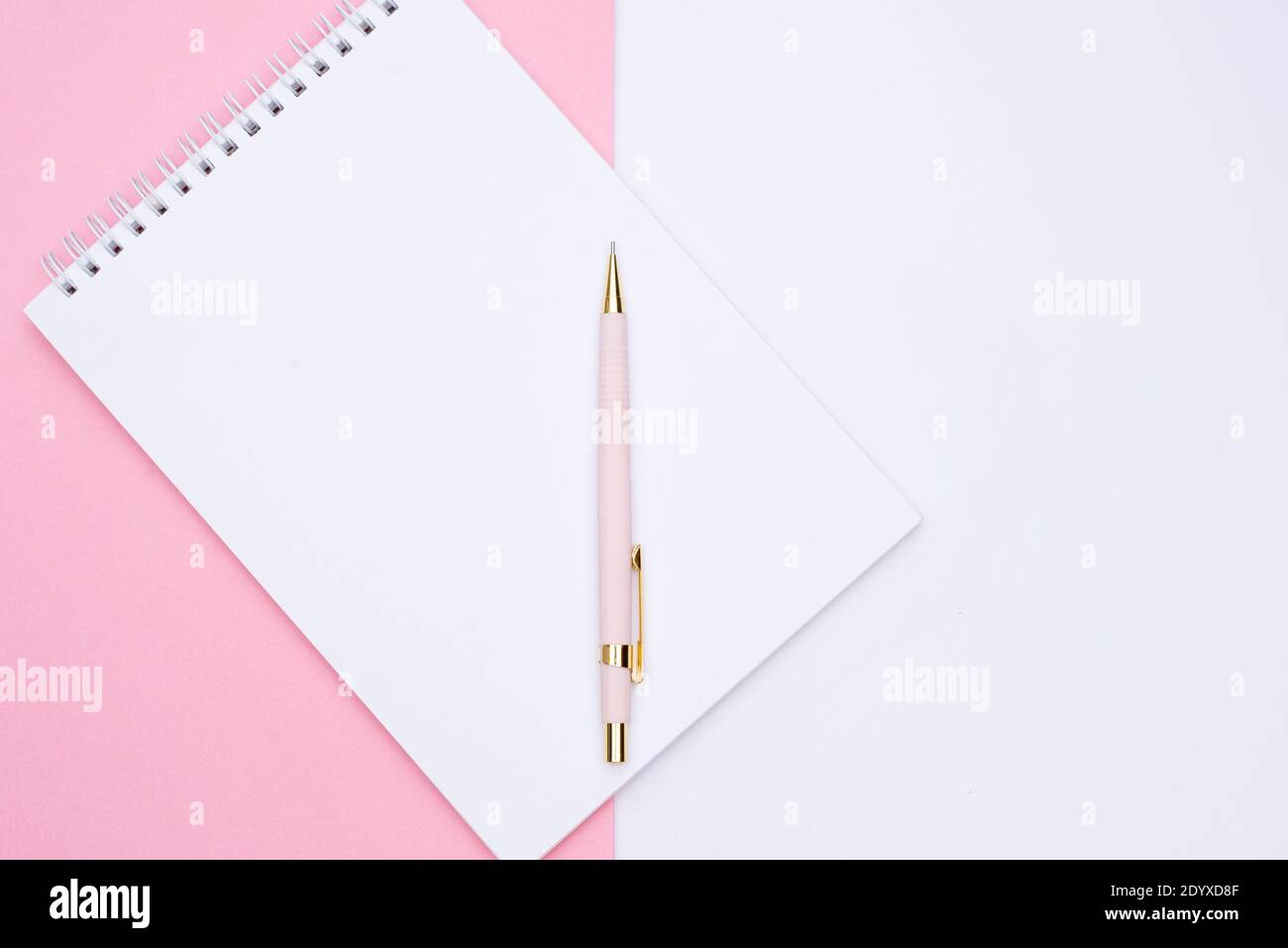 pink pen over note book on white background Stock Photo - Alamy