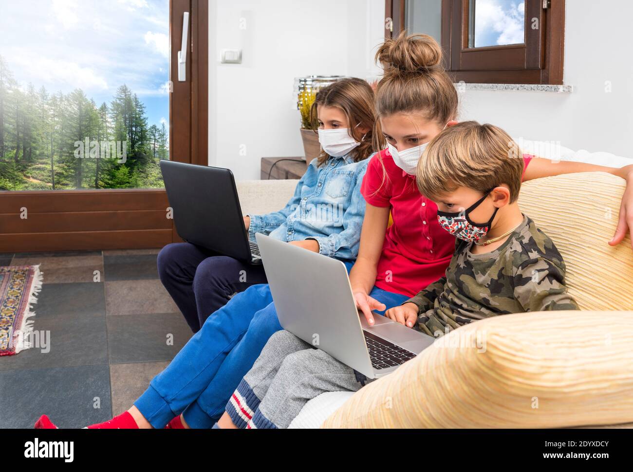 Children studies at home, wear protective masks, and doing school ...