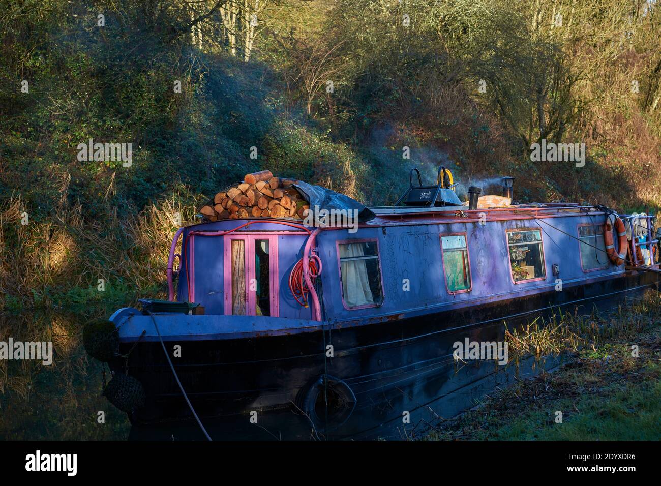 Narrowboats illuminated by the early morning winter sun along the ...