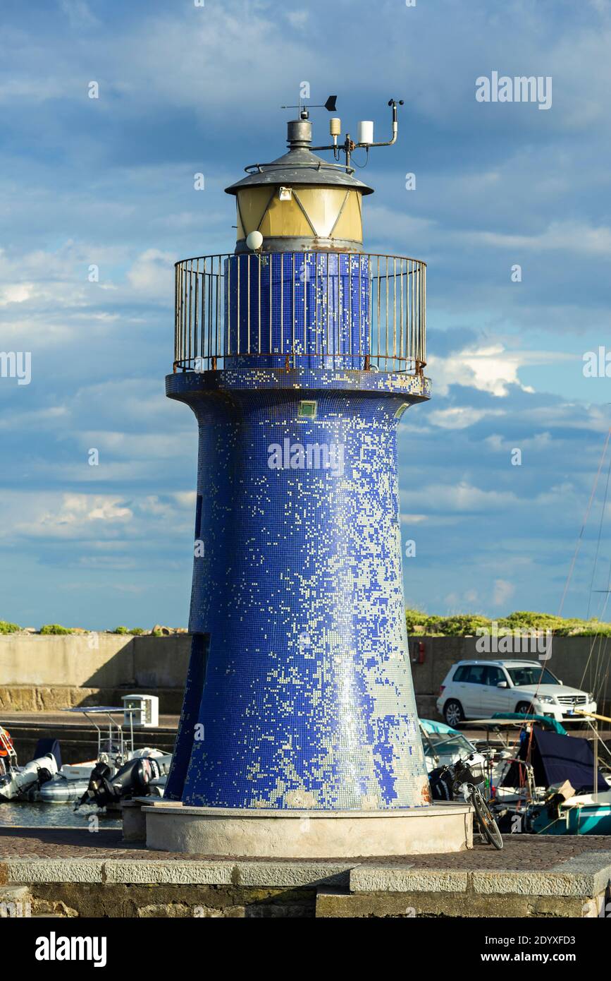 Blue lighthouse at the harbour entrance of Castiglione della Pescaia ...