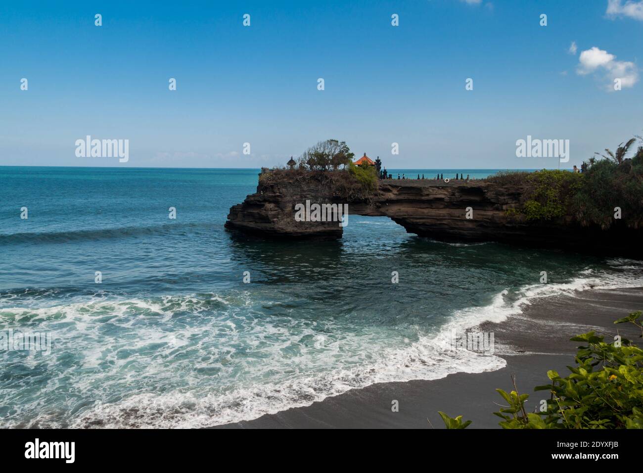 Natural bridge in the sea near Tanah Lot Temple in Bali and Batu Bolong ...