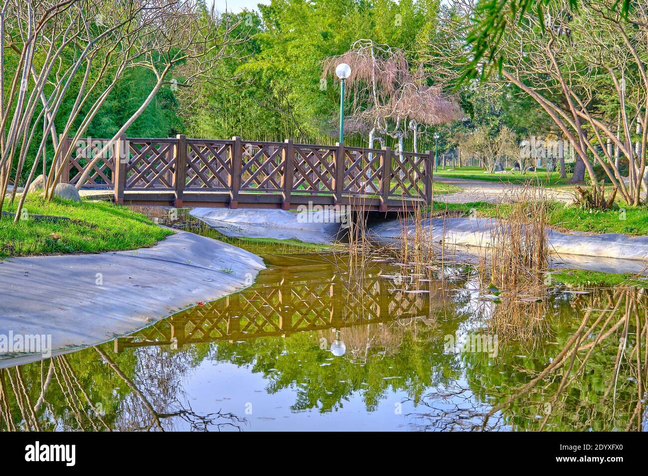 Cute and small bridge made of wooden and its reflection on the small ...