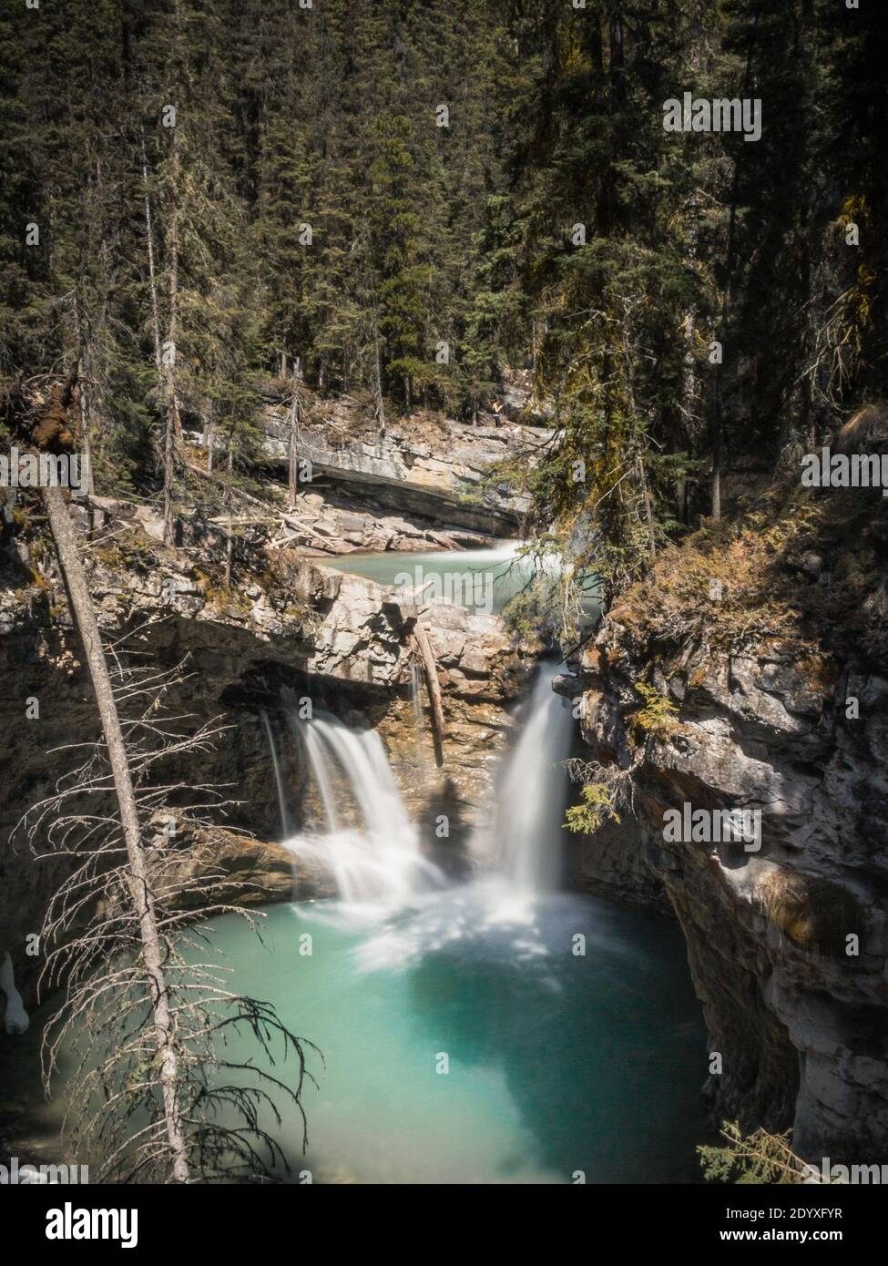Vertical shot of a waterfall in Johnston Canyon, Banff, Canada Stock ...