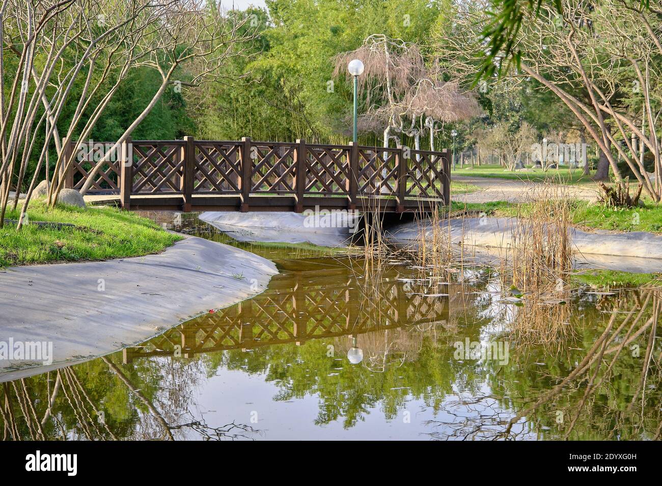 Cute and small bridge made of wooden and its reflection on the small ...